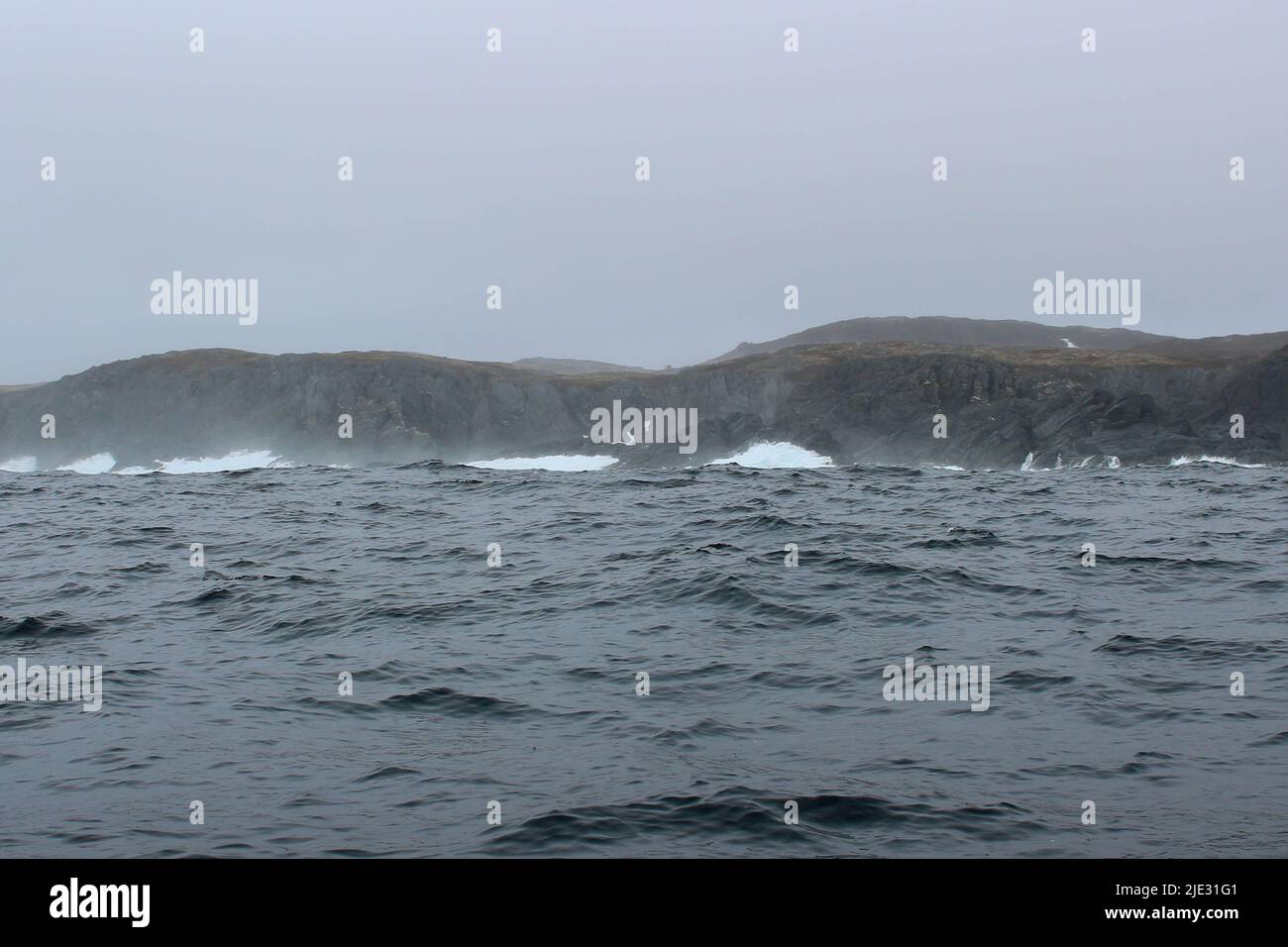 Wave crashing against small iceberg bit floating in sea Stock Photo - Alamy