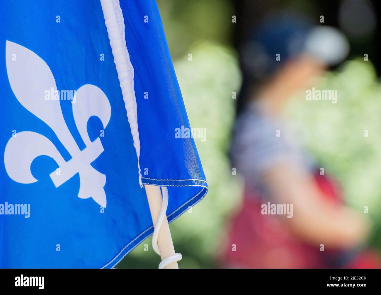 Montreal, Canada. 24th June 2022. People walk by a Quebec flag during a ...