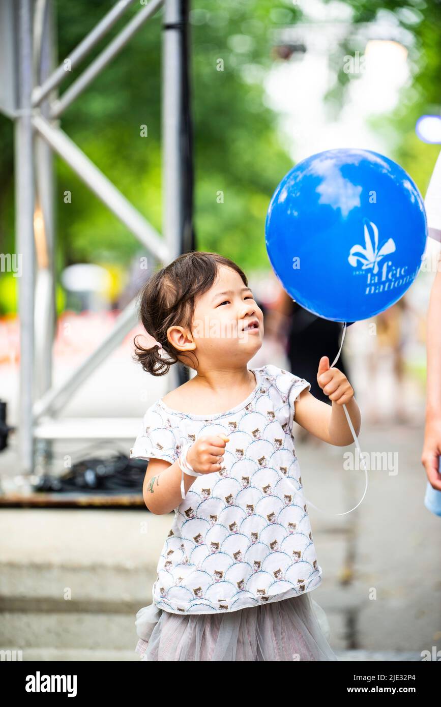 Montreal, Canada - June 24 2022: Little girl waving the Quebec ballon ...