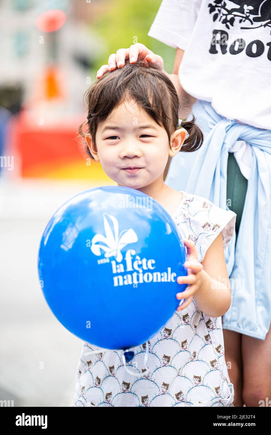 Montreal, Canada - June 24 2022: Little girl waving the Quebec ballon ...