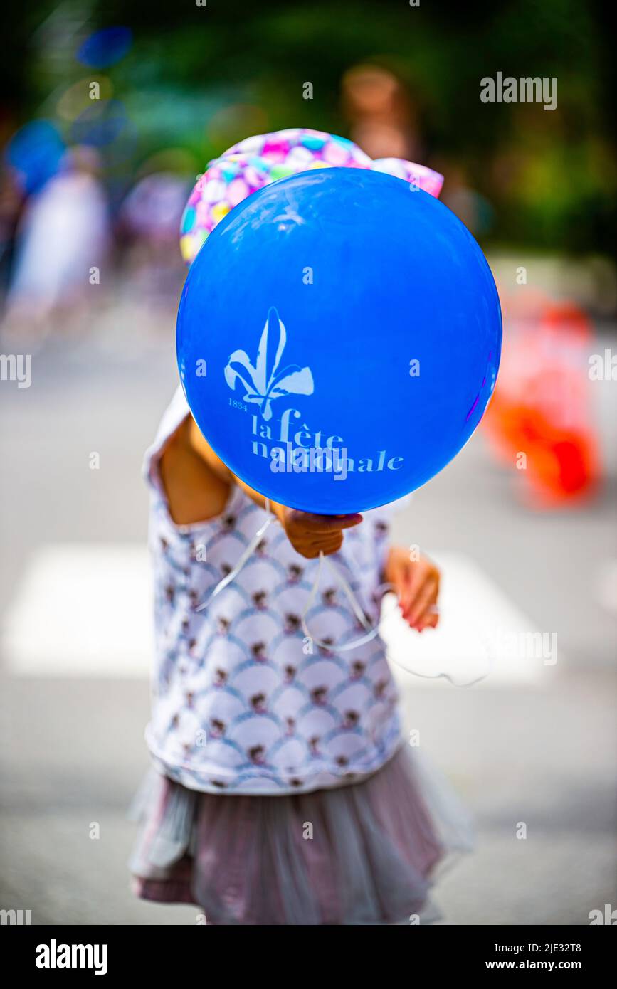 Montreal, Canada - June 24 2022: Little girl waving the Quebec ballon ...