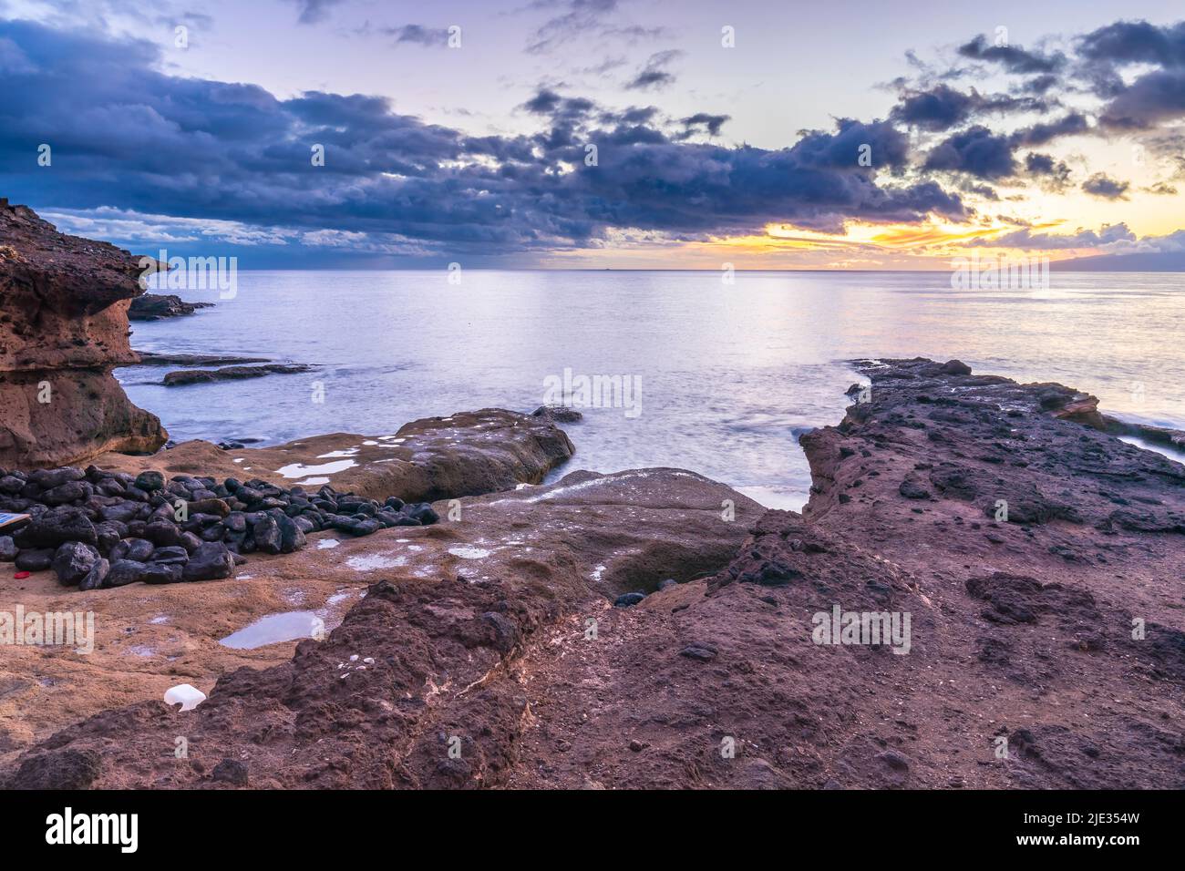 Beautiful sunset on Tenerife canary island coast with rocks and ...