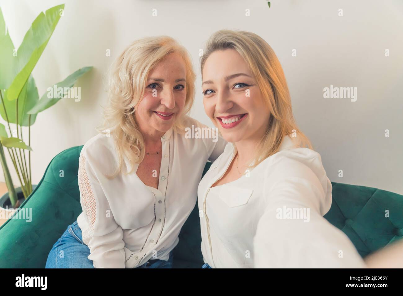 Horizontal indoor shot in an apartment of two blonde well-dressed ...