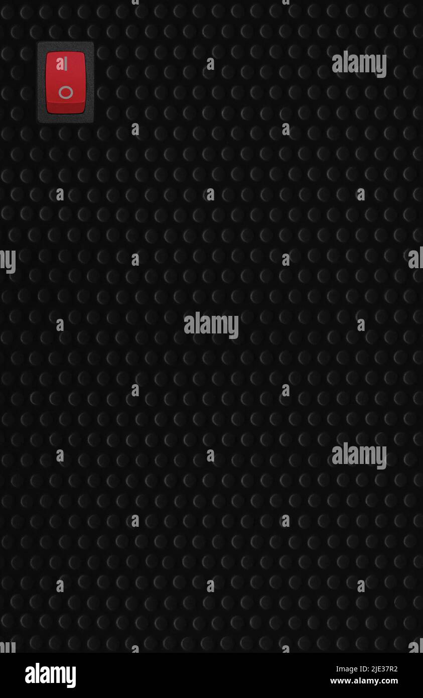 Red rectangle rocker power switch in on position, black abstract dot ...