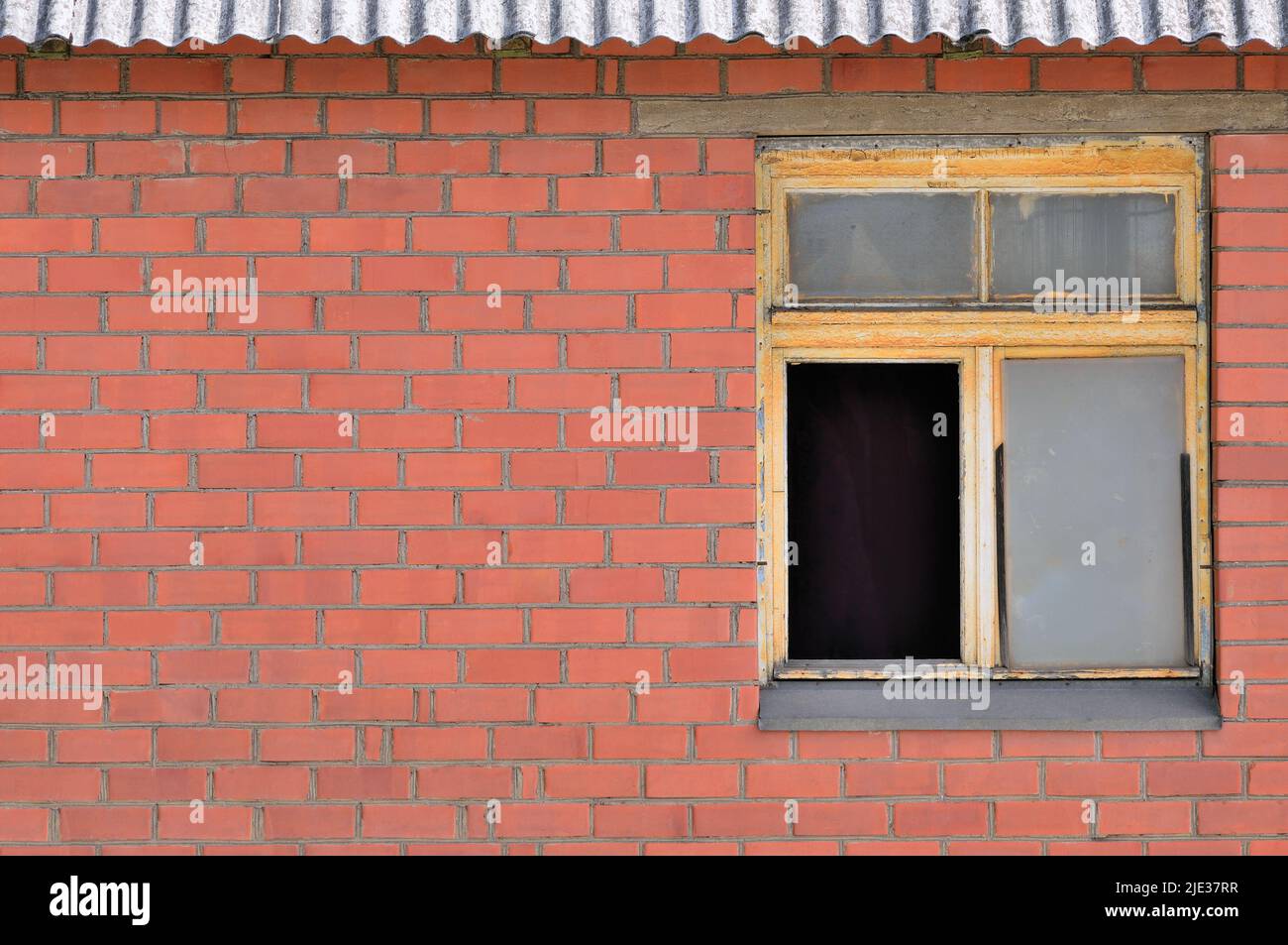 Old aged shed broken window glass, red bricks hut wall background ...