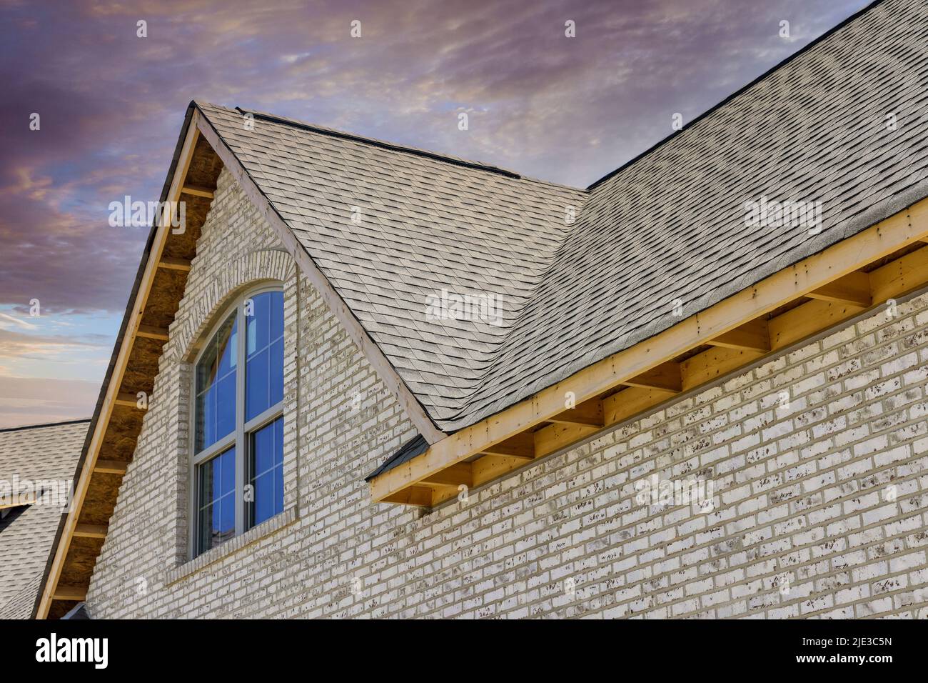 A new house is being constructed with asphalt shingles and ...