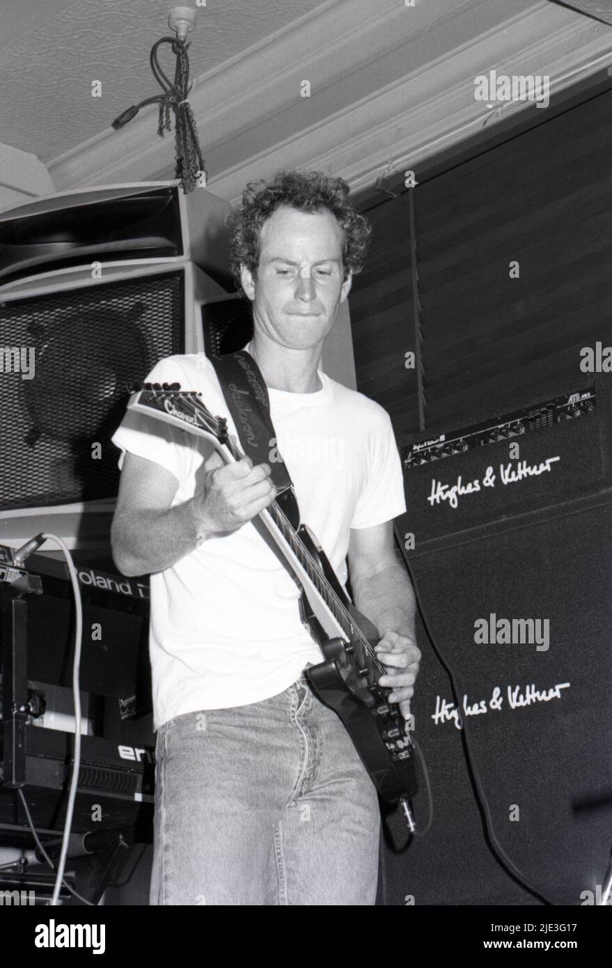 Tennis player John McEnroe playing electric guitar duing a jam session ...
