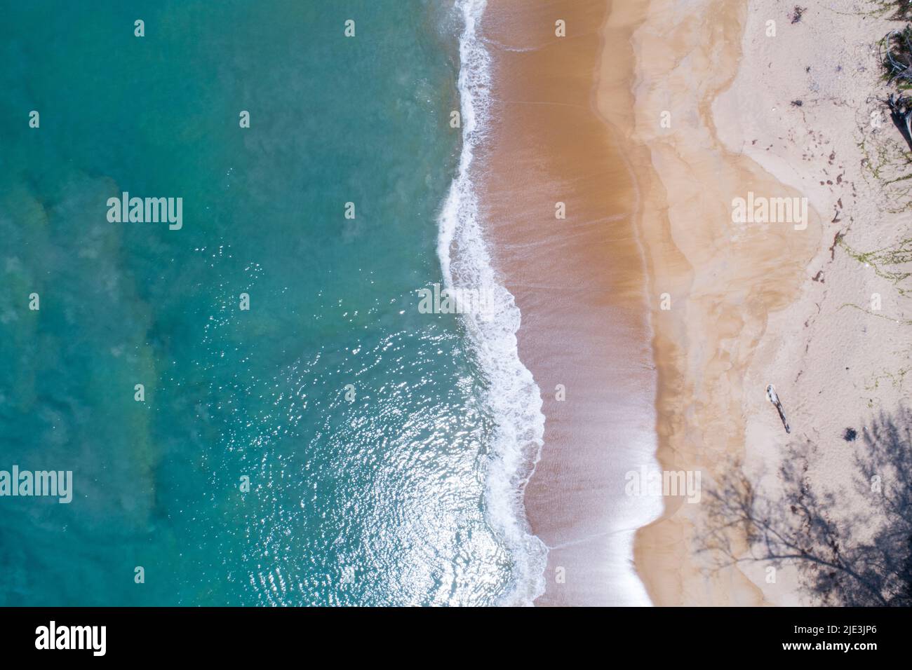 Sea background Aerial view Top down sea waves crashing on sandy beach ...