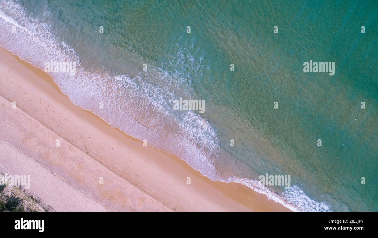 Sea background Aerial view Top down sea waves crashing on sandy beach ...