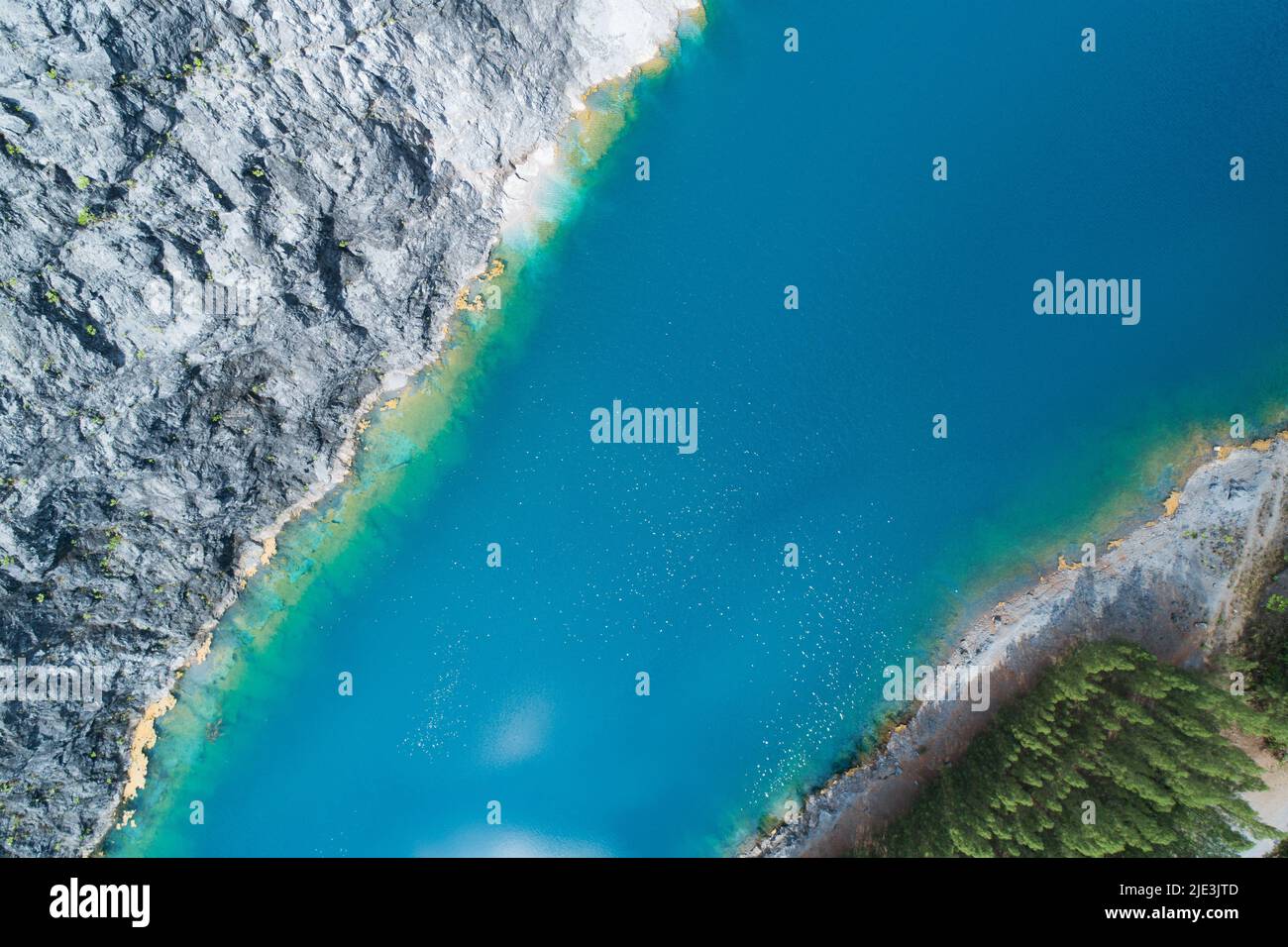 Aerial view of amazing pond in tropical rainforest forest with mountain ...