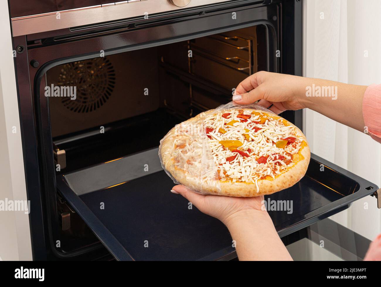 Italian pizza with cheese and tomatoes cooking dinner in a modern ...