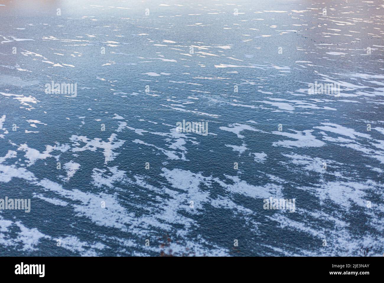 Weathered ice on the lake. Frozen water on the river. Texture of the ...