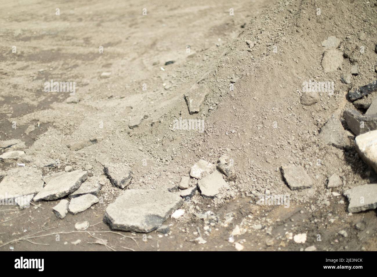 Stones on asphalt. Broken stone on street. Ruined structure ...