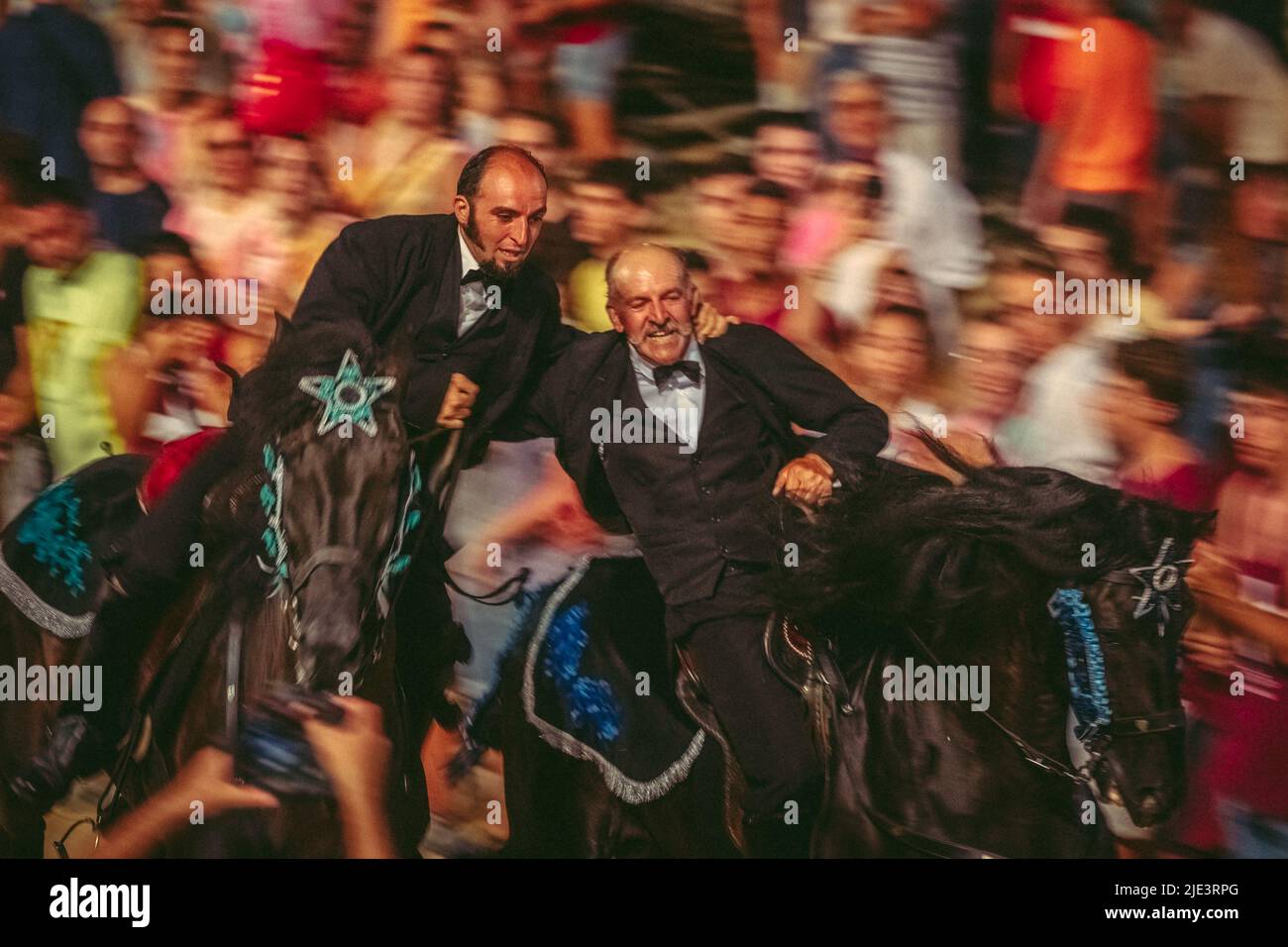 Ciutadella, Spain. 24th June, 2022. Two 'caixers' (horse riders) gallop ...