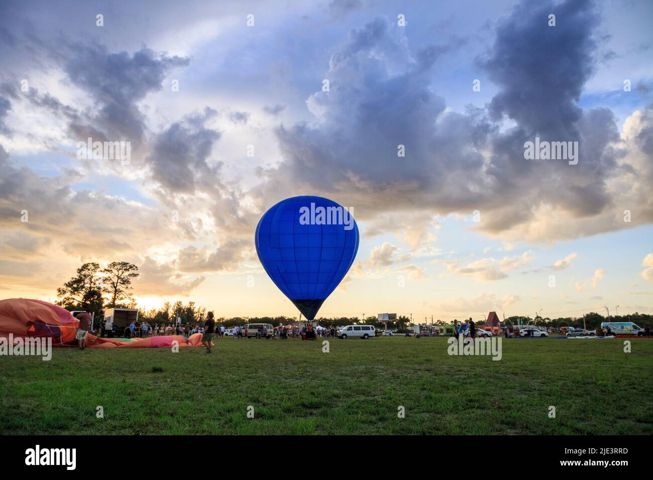Blue hot air balloon gets ready for takeoff at sunset in Los Angeles ...