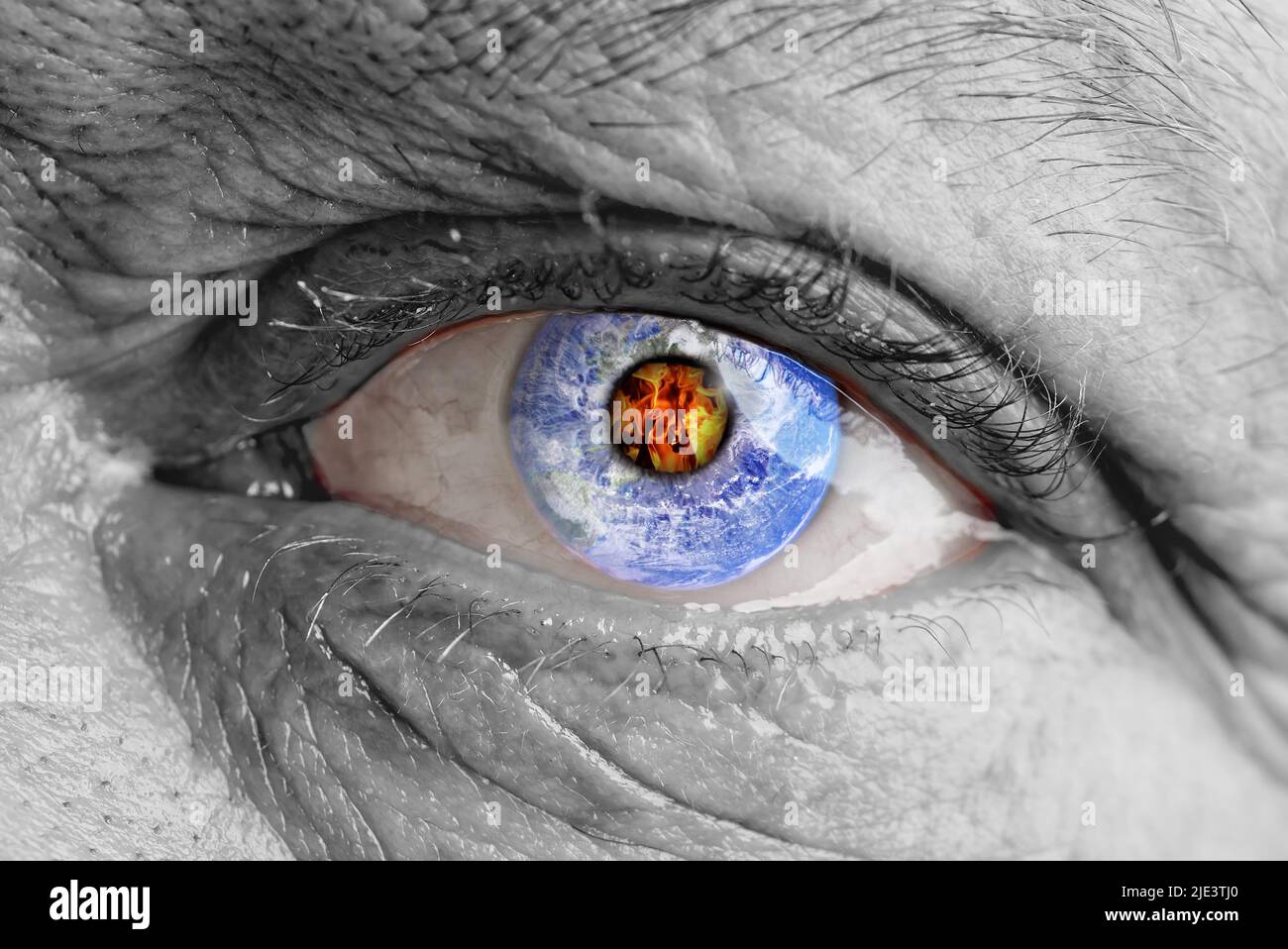 The earth globe inside of a man's eye. the concept of the destruction ...