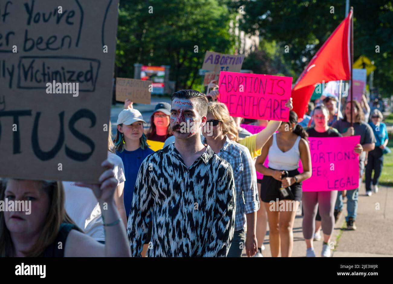 Demonstrators march holding placards outside the Luzerne County ...