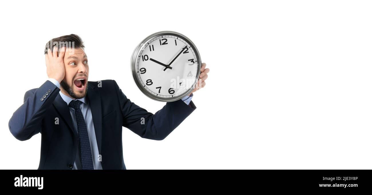 Stressed businessman holding clock on white background with space for ...