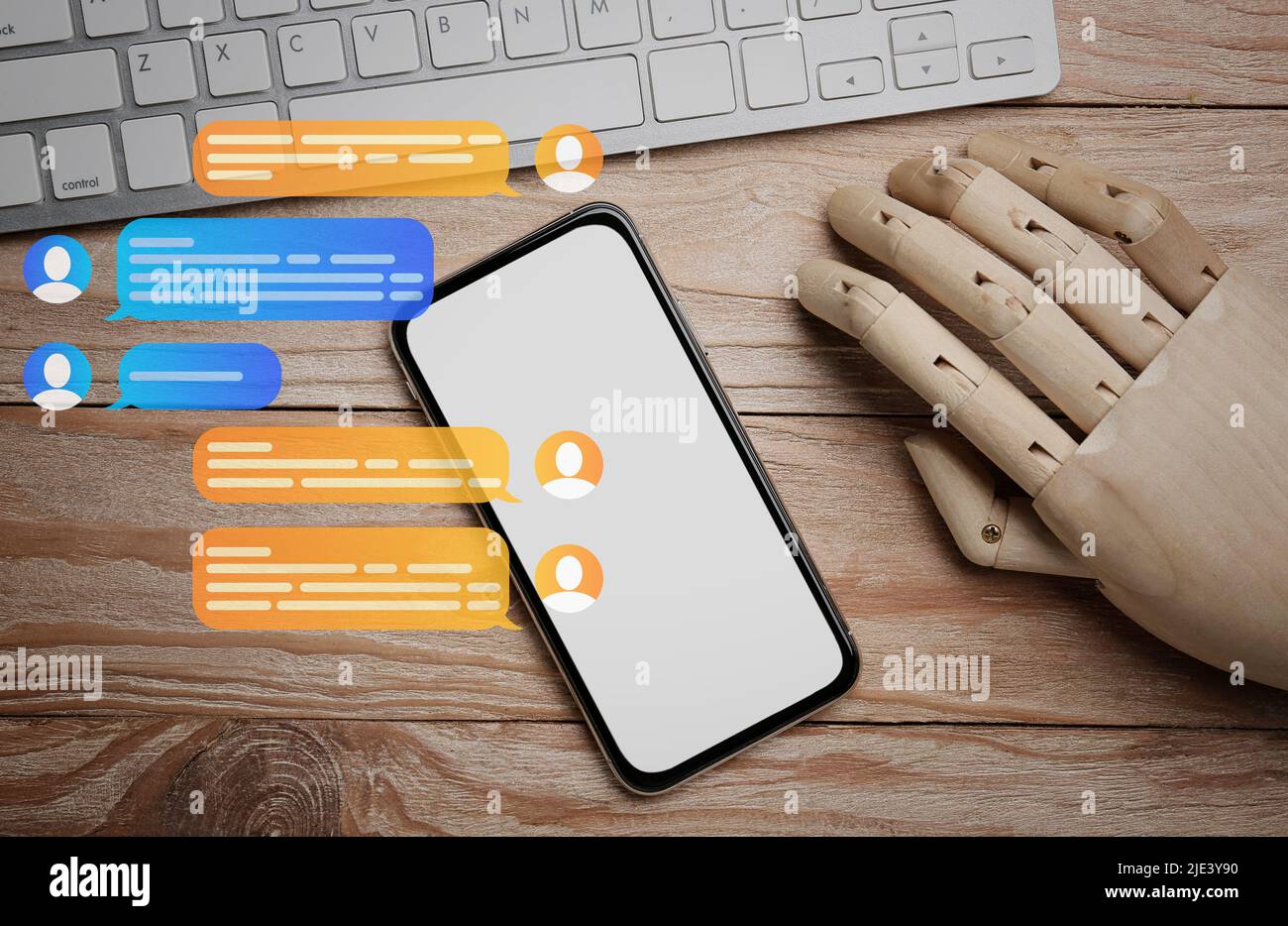 Mobile phone with mannequin hand and computer keyboard on wooden ...