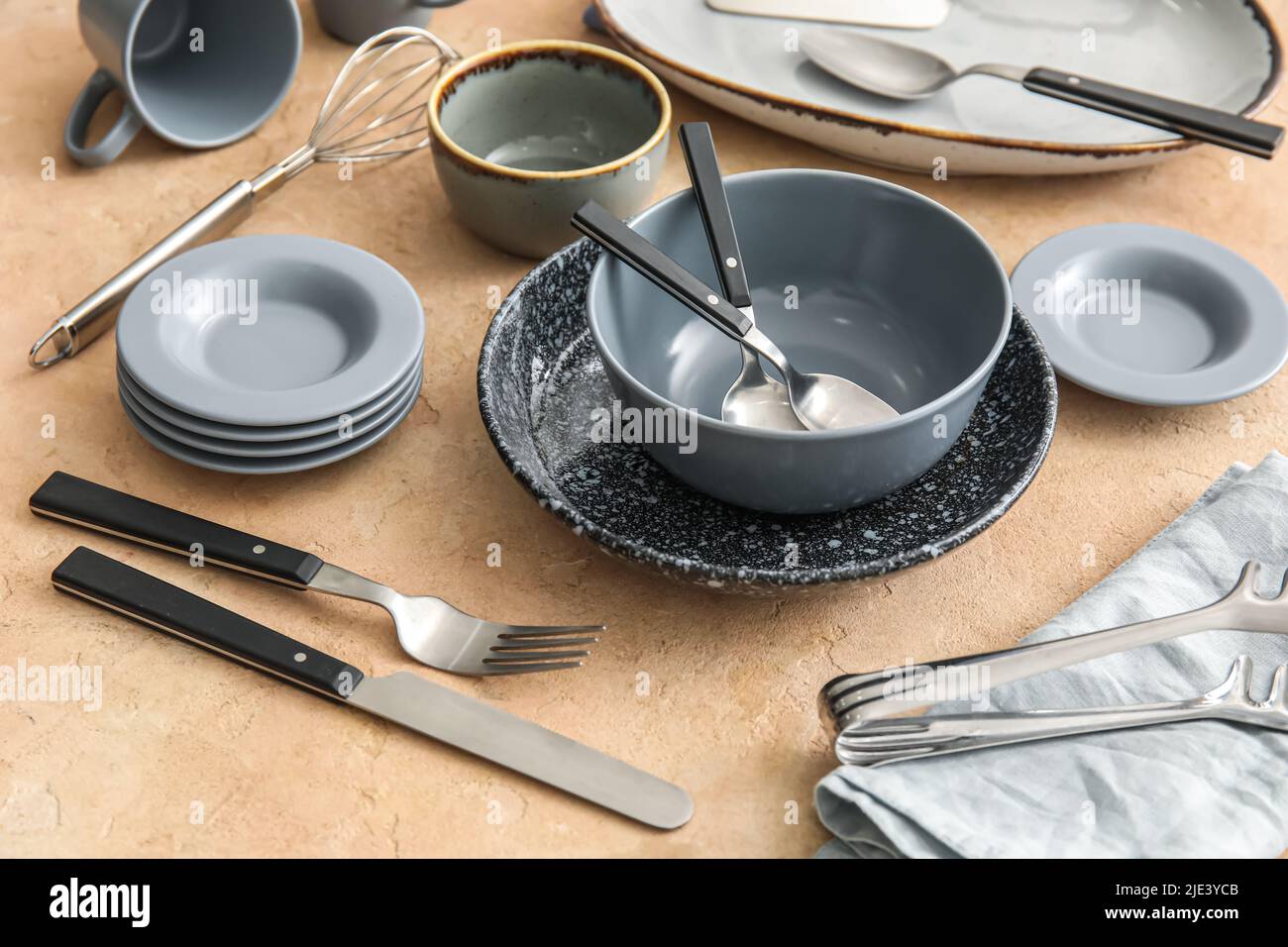 Set of dinnerware on beige table Stock Photo - Alamy