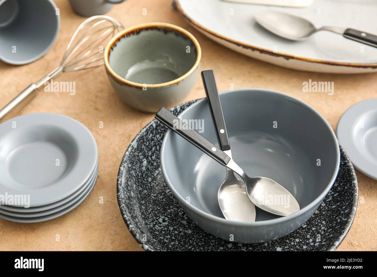Set of dinnerware on beige table Stock Photo - Alamy