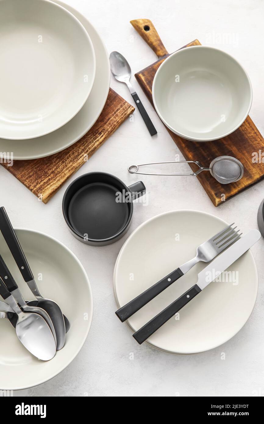 Set of clean dinnerware on light background Stock Photo - Alamy