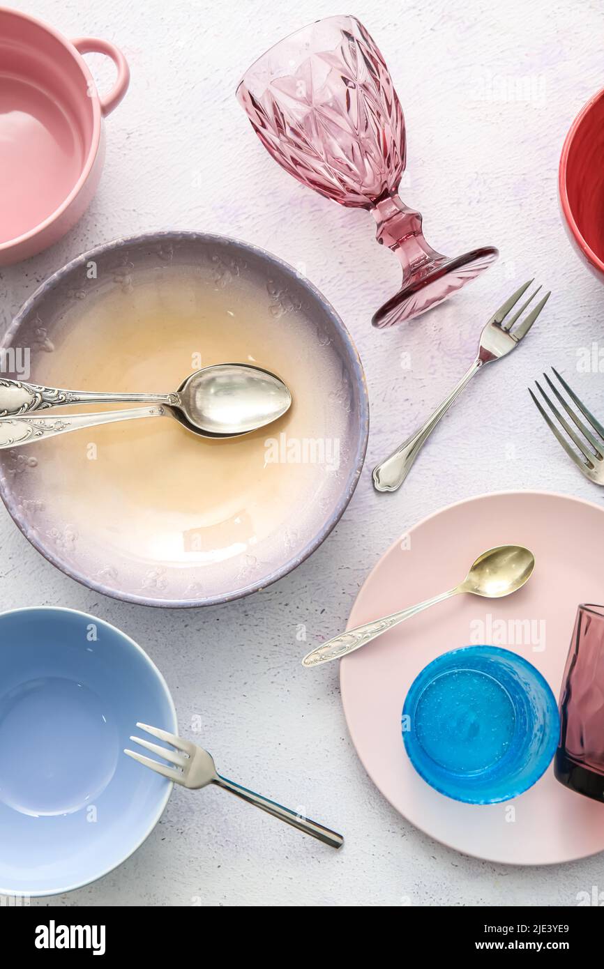 Different dinnerware on light background Stock Photo - Alamy