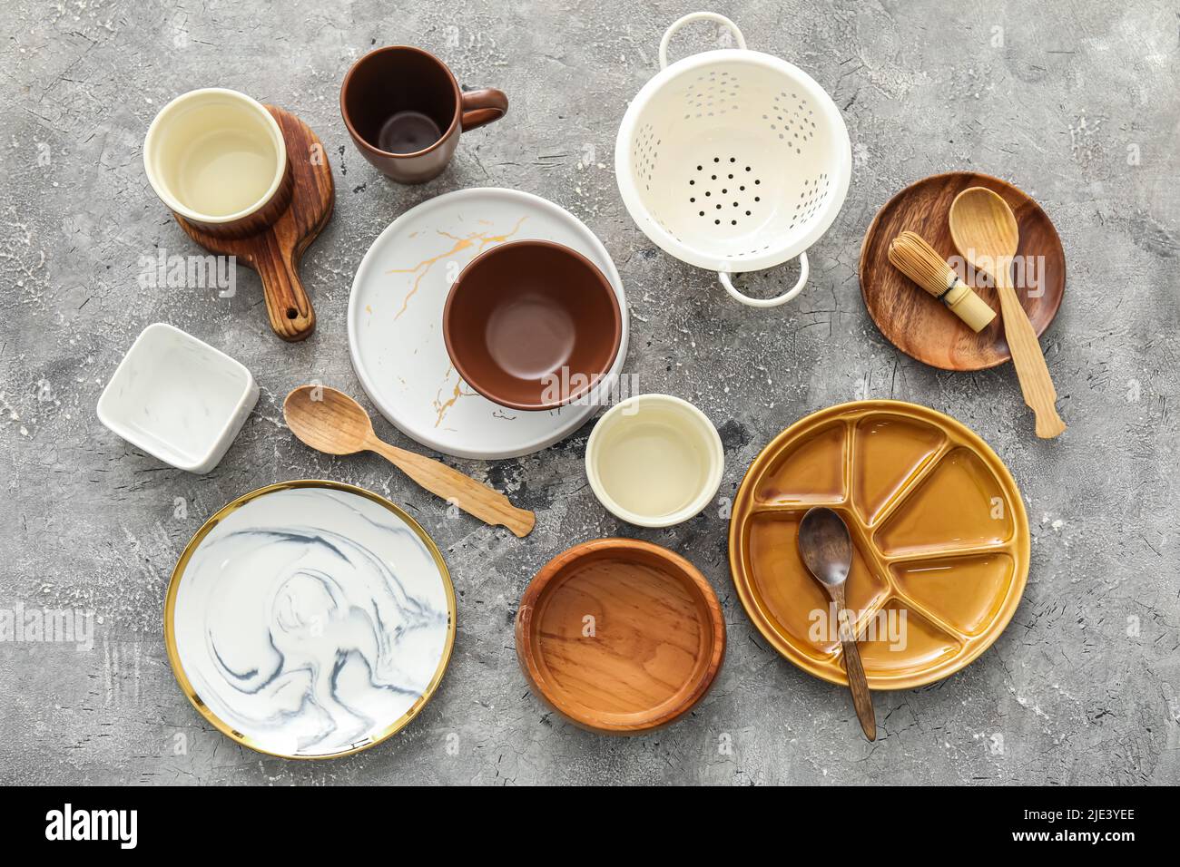 Different dinnerware on grunge background Stock Photo - Alamy