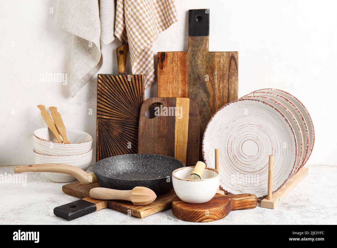 Clean kitchen utensils and dinnerware on light background Stock Photo ...