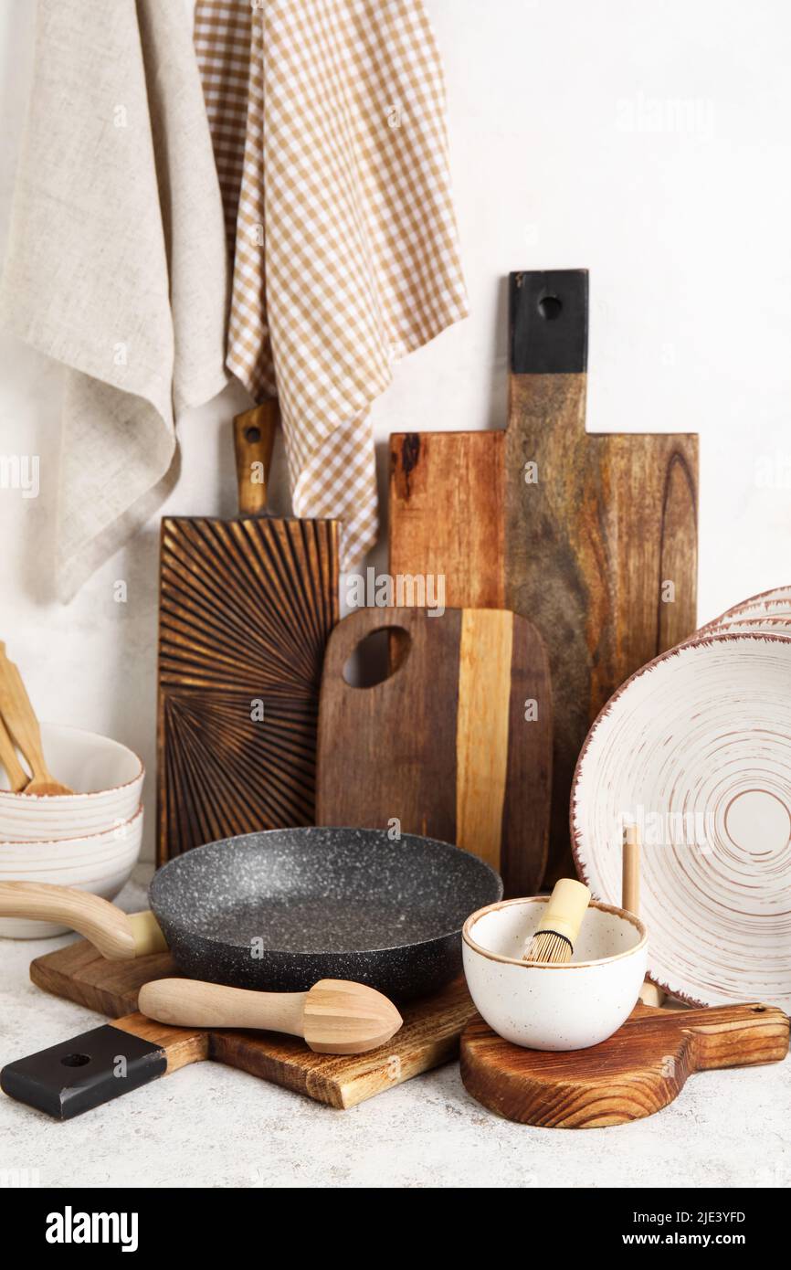 Clean kitchen utensils and dinnerware on light background Stock Photo ...