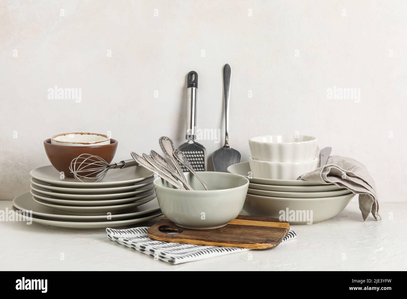 Set of clean dinnerware on light background Stock Photo - Alamy