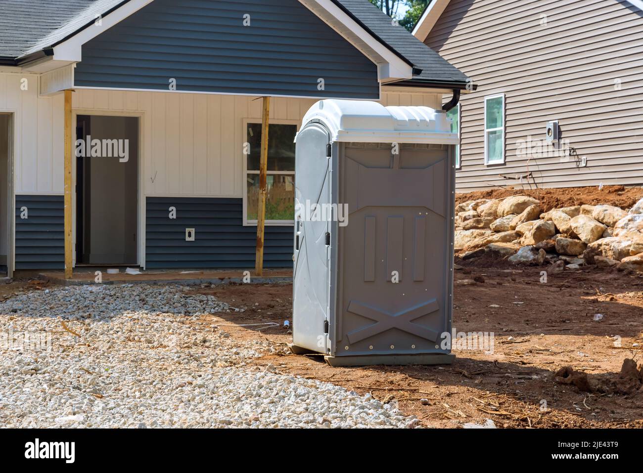 Construction site portable restroom for workers on a house under ...