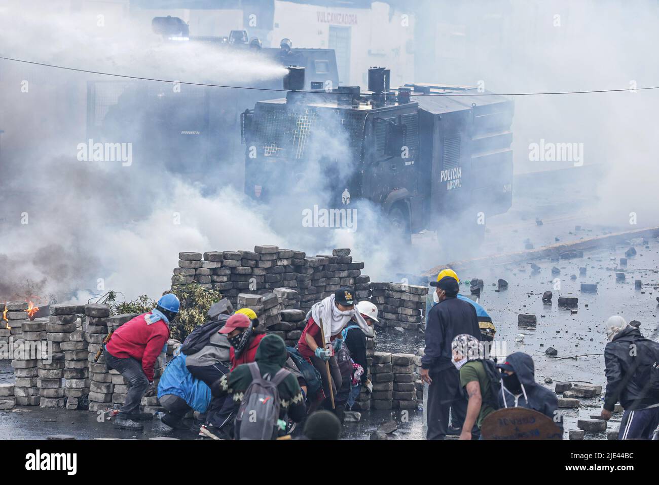 Quito, Ecuador. 23rd June, 2022. Protesters take cover from a Riot ...