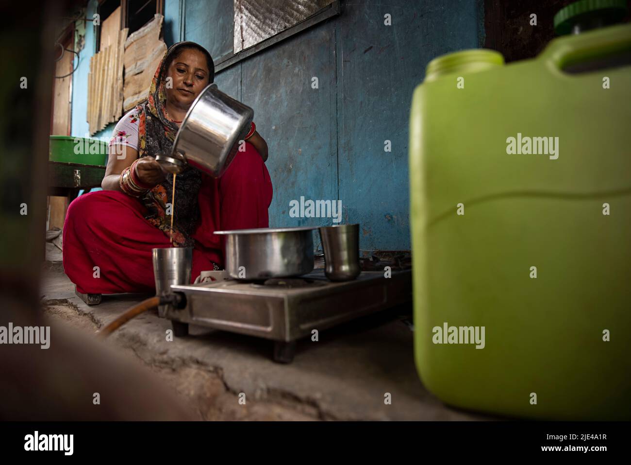 Indian woman making hot tea hi-res stock photography and images - Alamy