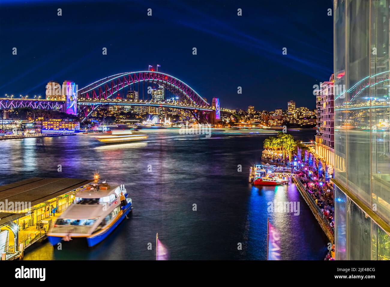 Reflection of Sydney Harbour bridge in glass wall of Circular QUay area ...