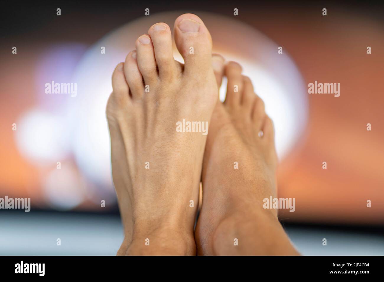 Man feet on colourful background. Male toes Stock Photo - Alamy
