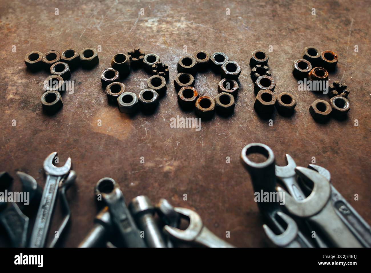 the word Tools written by nuts and a set of wrenches Stock Photo - Alamy