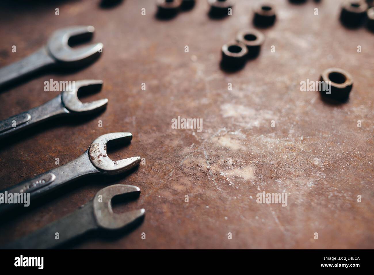 Wrenches and nuts metal background Stock Photo - Alamy