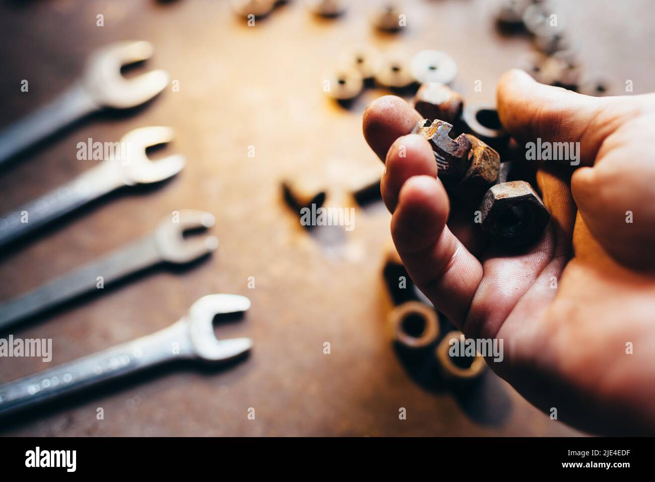 The male hand holds old nuts Stock Photo - Alamy