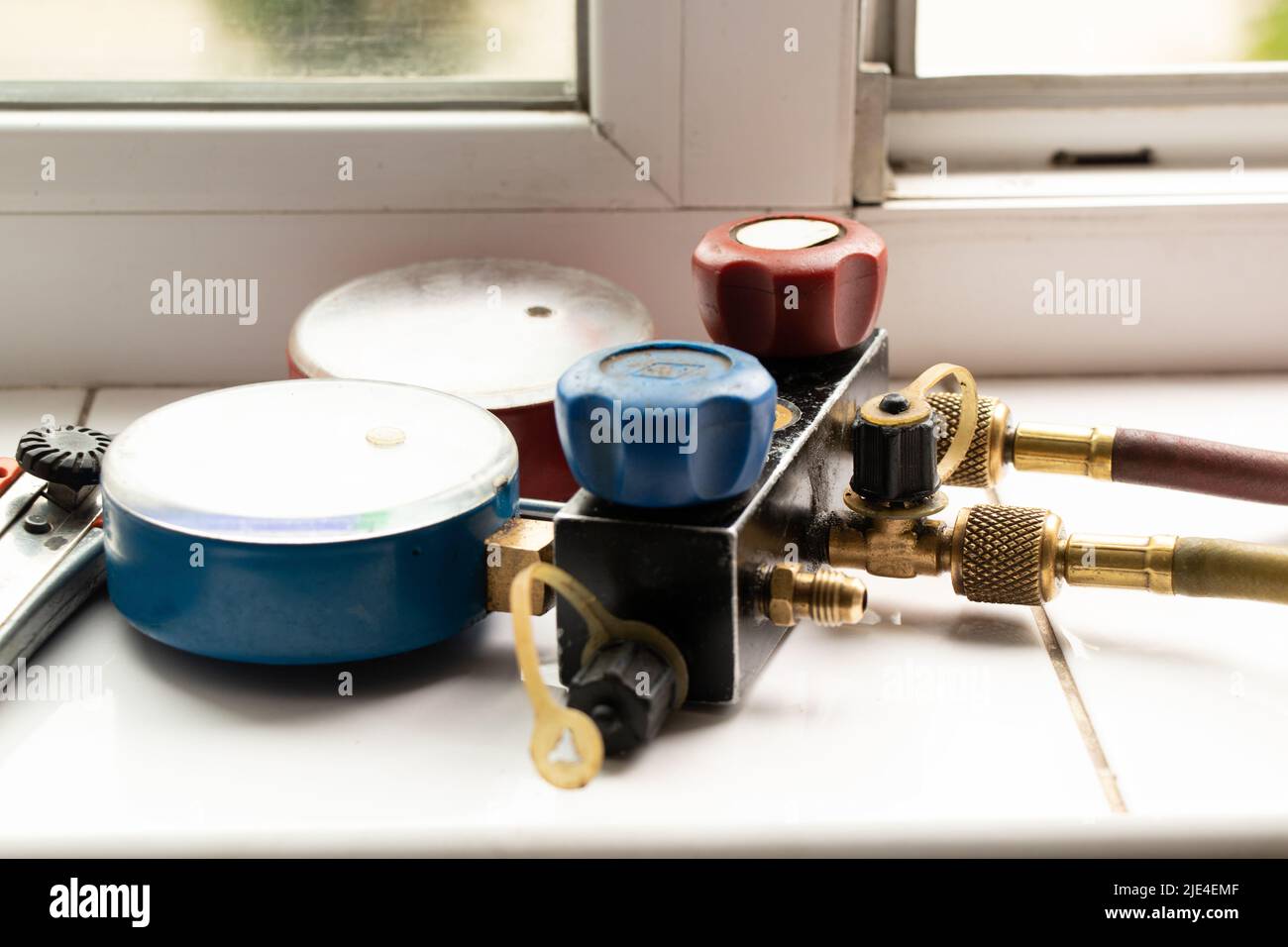 The two-valve manometric manifold lies on the windowsill in the ...