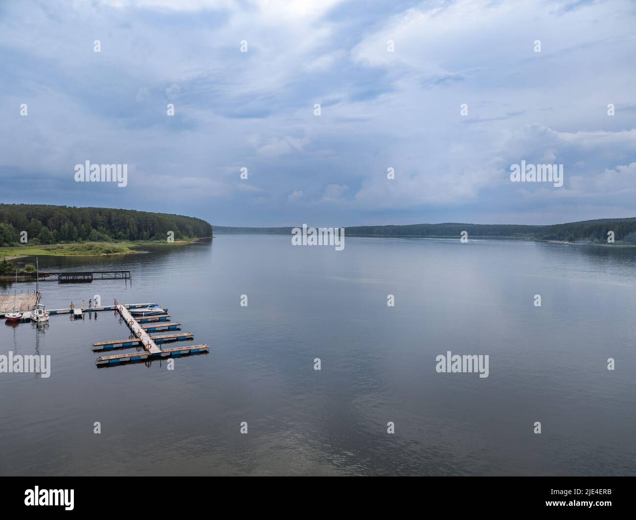 Big lake with green shores in bright sun light, aerial landscape ...