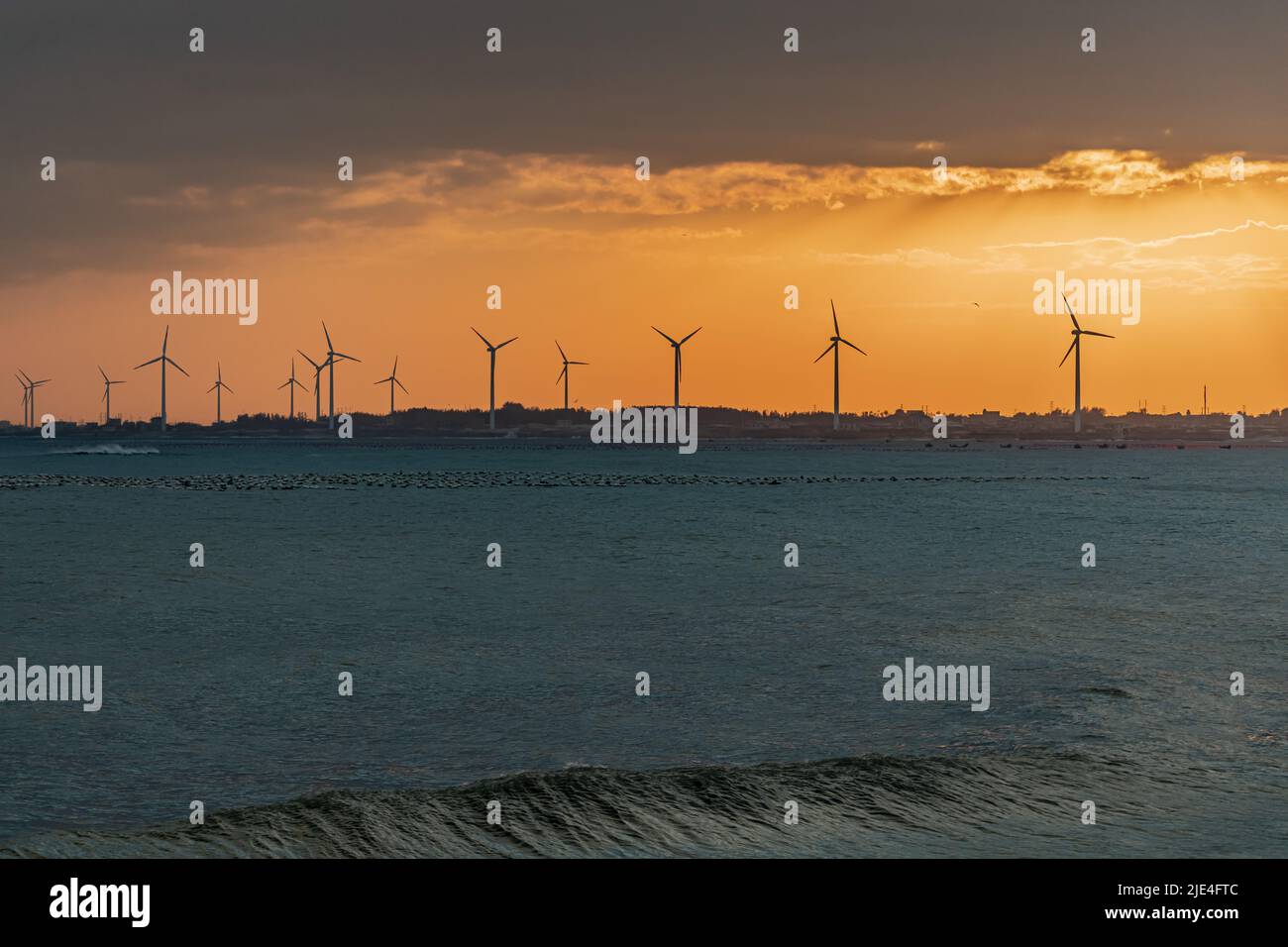 Sunset the sea the sun the golden windmills Stock Photo - Alamy