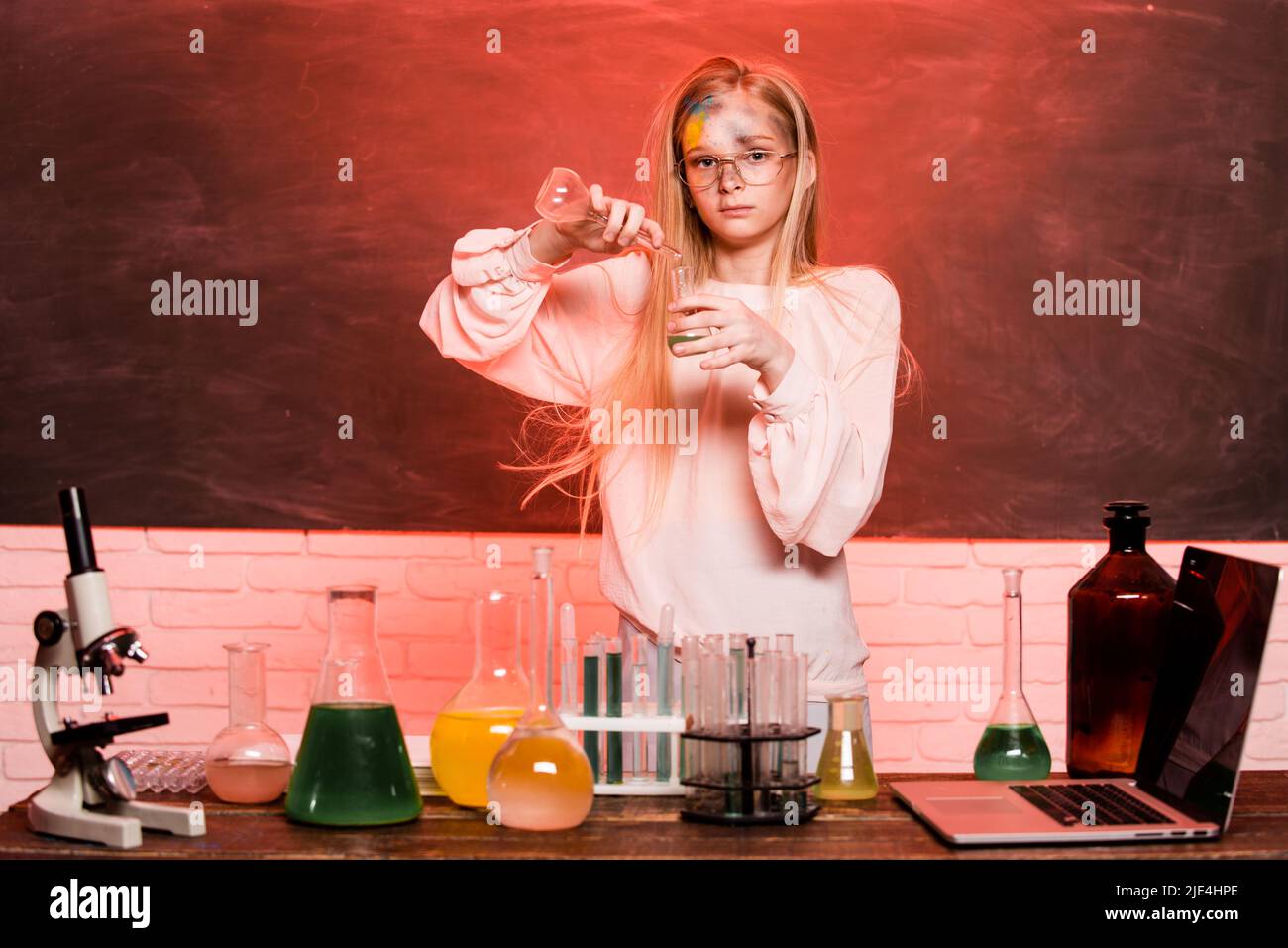 Science lab chemistry test. Funny little school child doing experiments ...