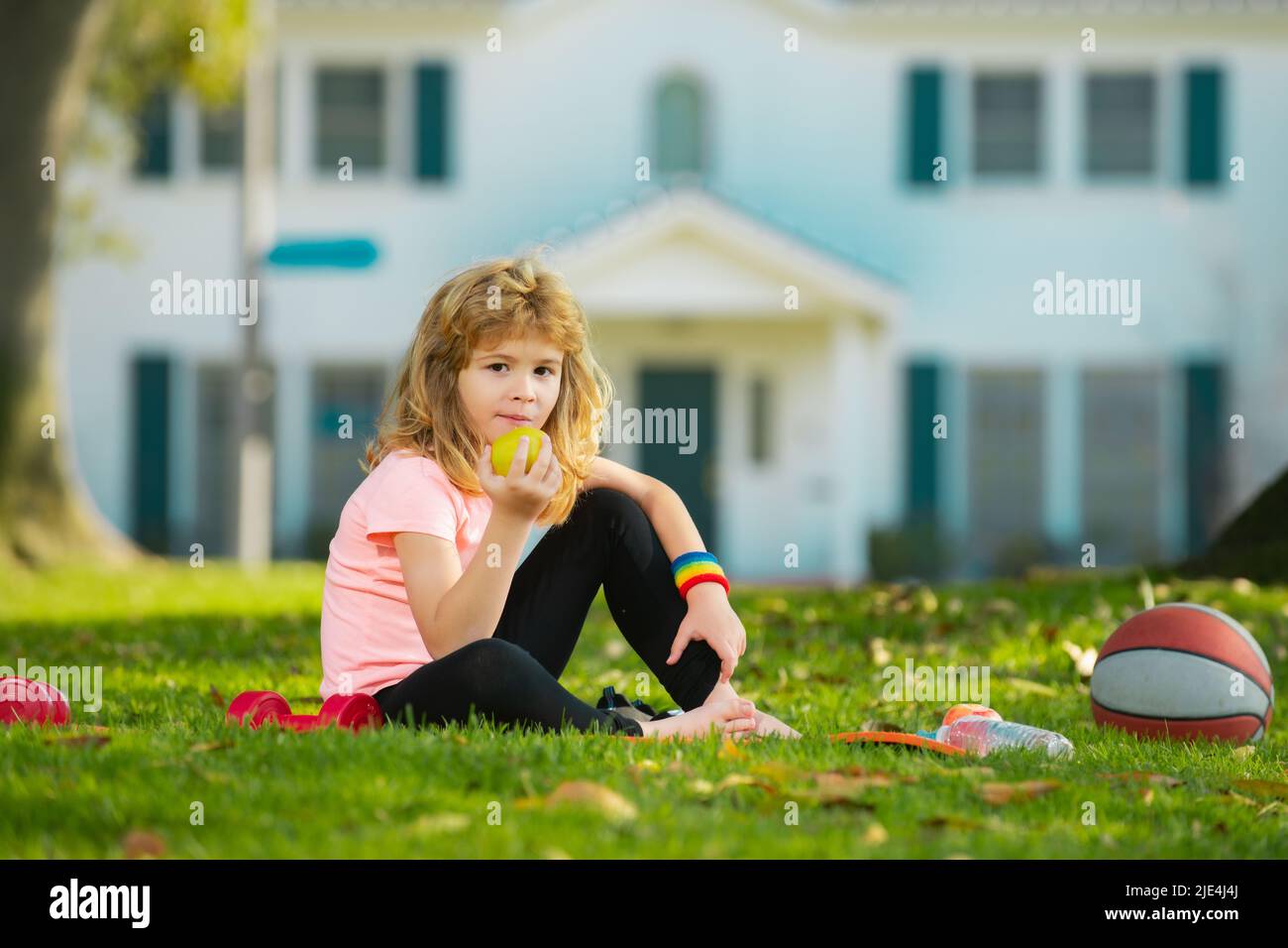 Child boy eating healthy food, eating apple after exercise. Fitness ...