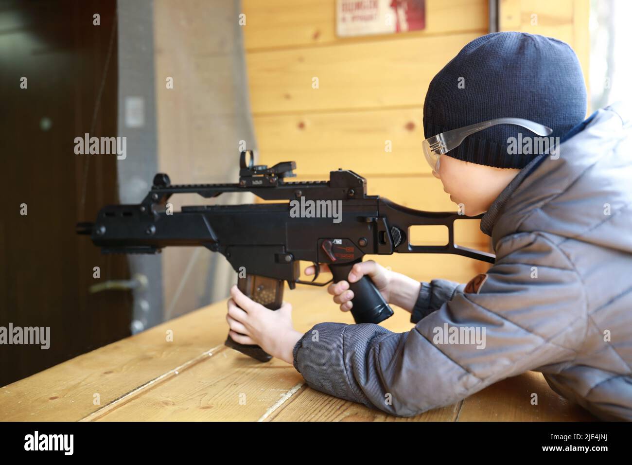 Child shooting rifle in hi-res stock photography and images - Alamy