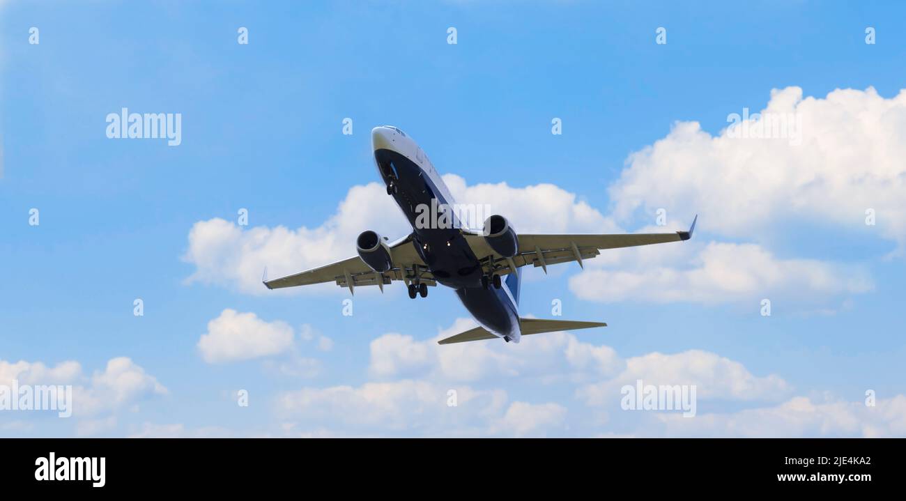 Long shot of the underbelly of a flying plane Stock Photo - Alamy