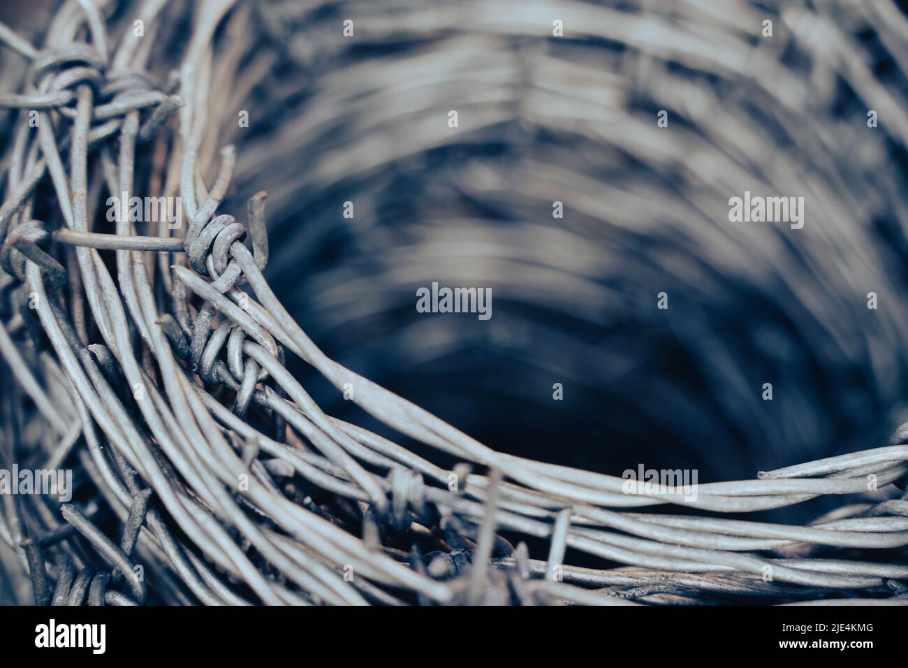 macro closeup of large roll of steel barbed wire used for fence ...