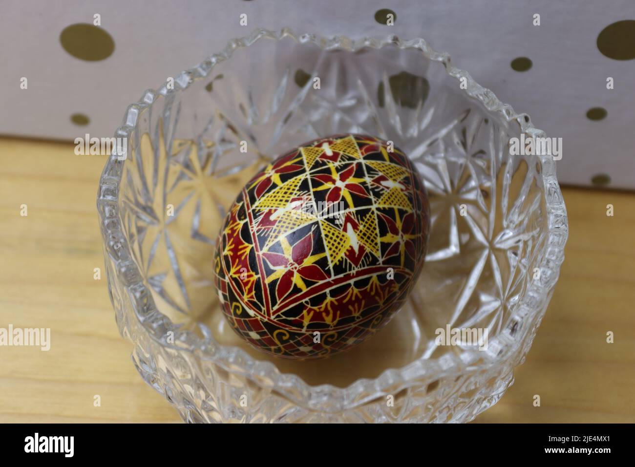 Decorative hand-painted Easter Egg being located in a glass vessel ...