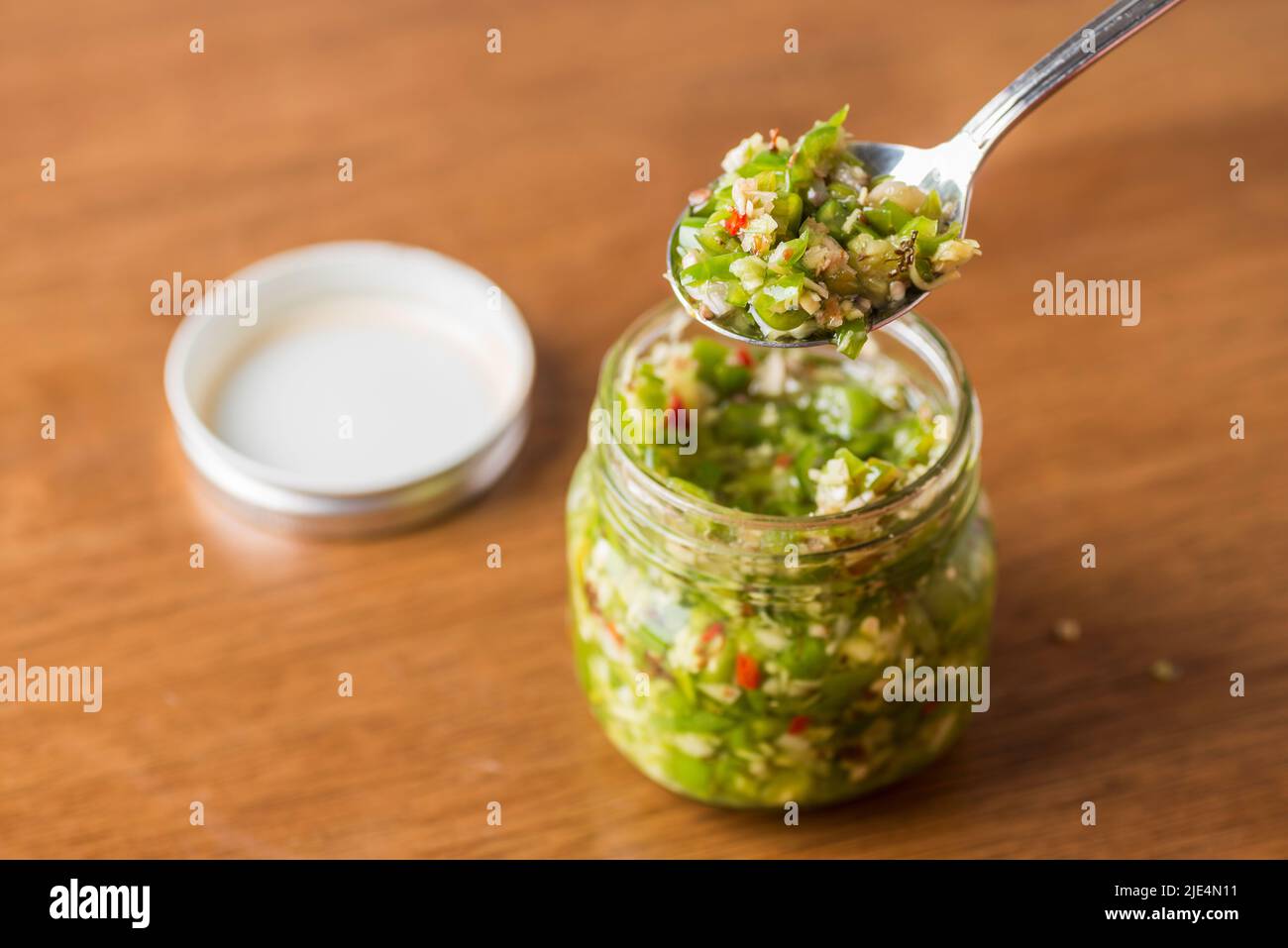 Glass bottles of manual magnificent green chilli sauce Stock Photo - Alamy