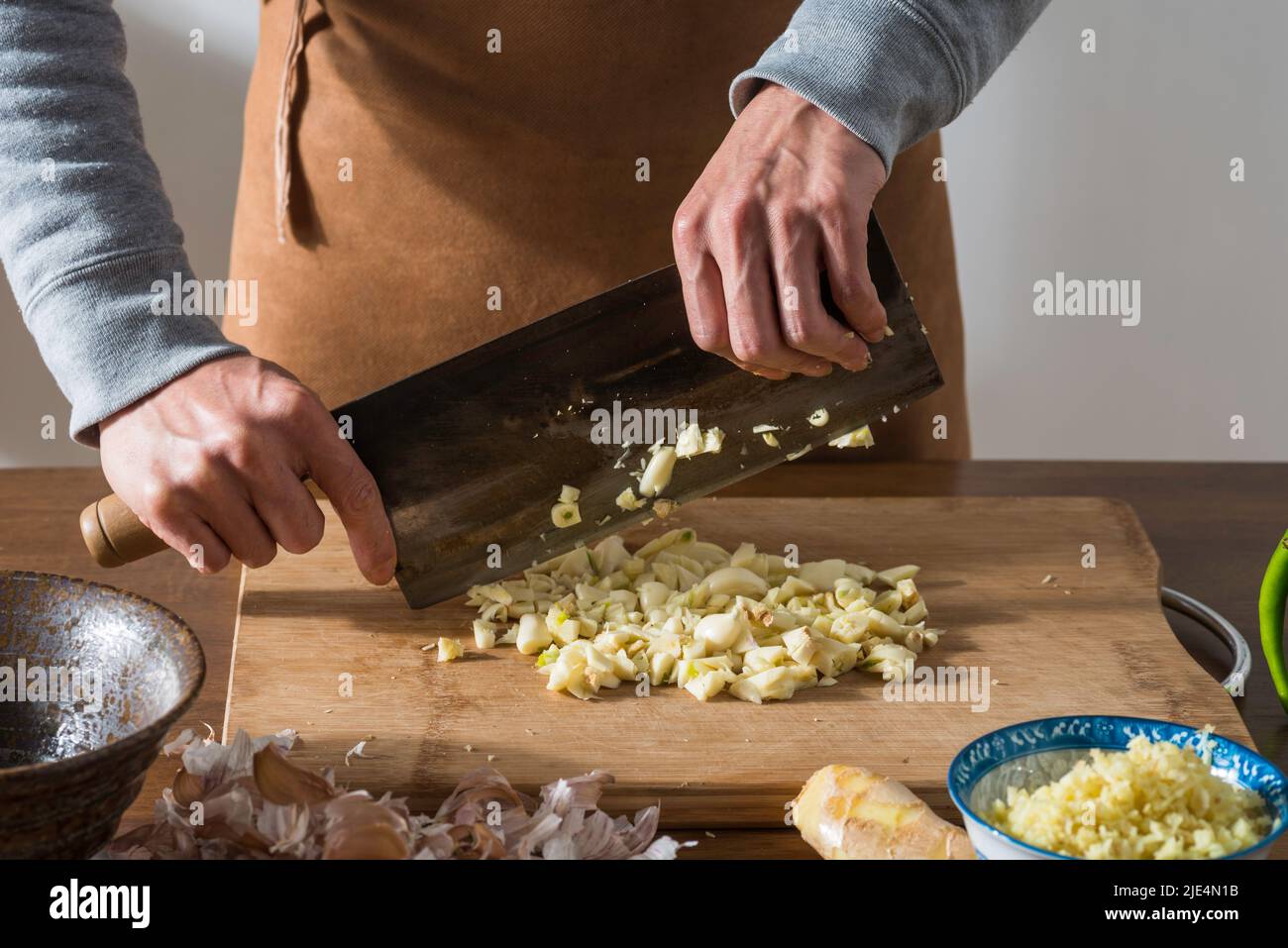 Chef hand chopper on the boards at the end of the chopped garlic Stock ...